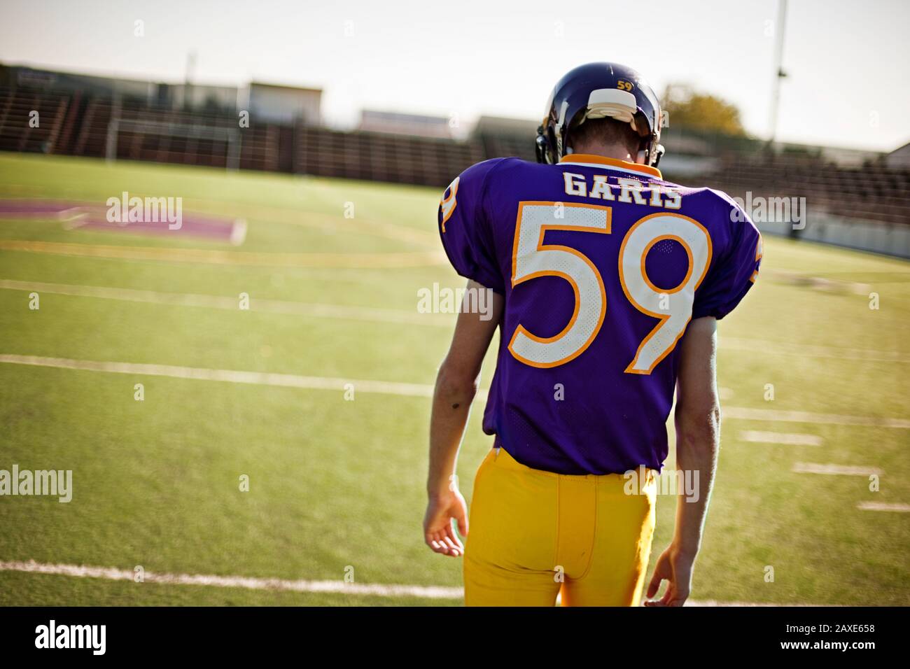 Football player and cheerleader holding hands on football field Stock ...