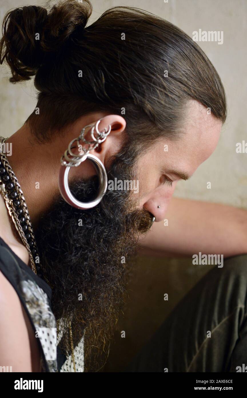 Men with long hair and beard piercings Stock Photo - Alamy