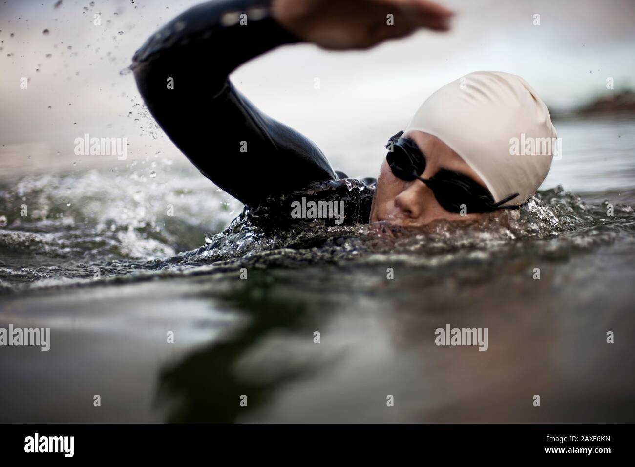 Young female swimmer training at the beach Stock Photo - Alamy