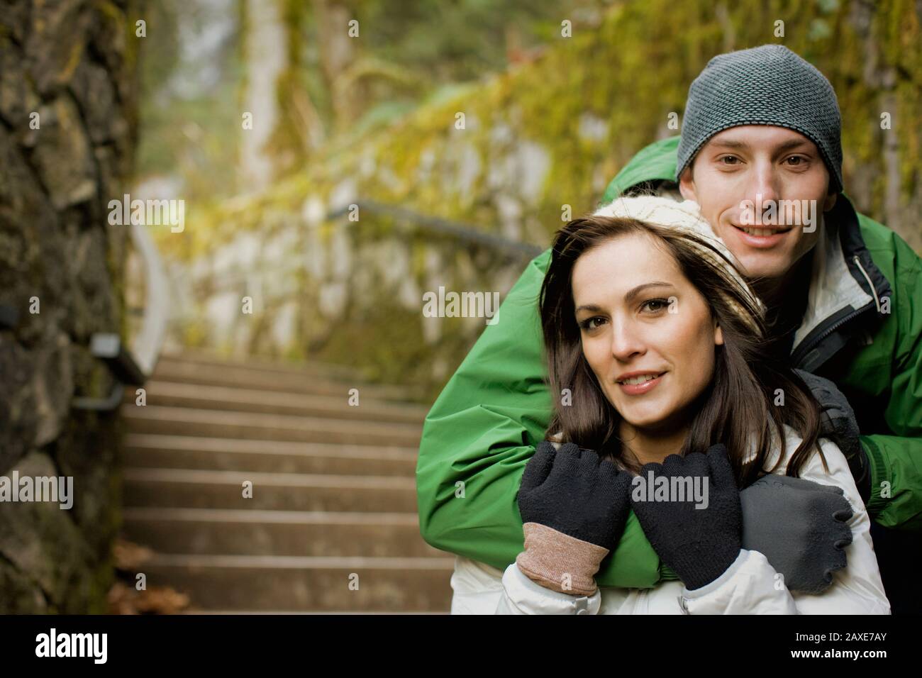 Young couple with arms around each other Stock Photo - Alamy