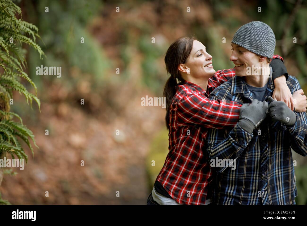 Young couple with arms around each other Stock Photo - Alamy