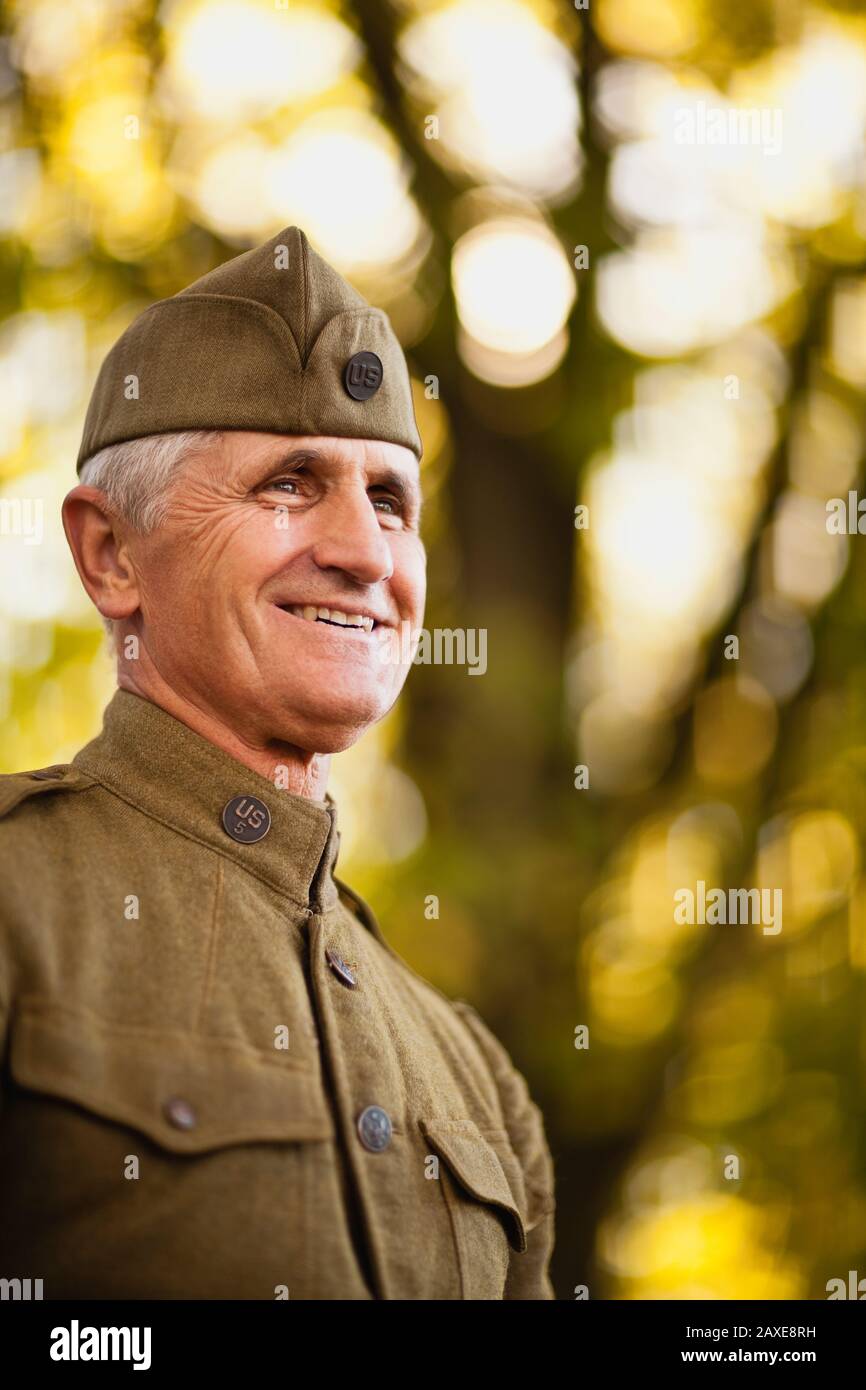Mature male reenactor wearing an American World War II side cap and ...