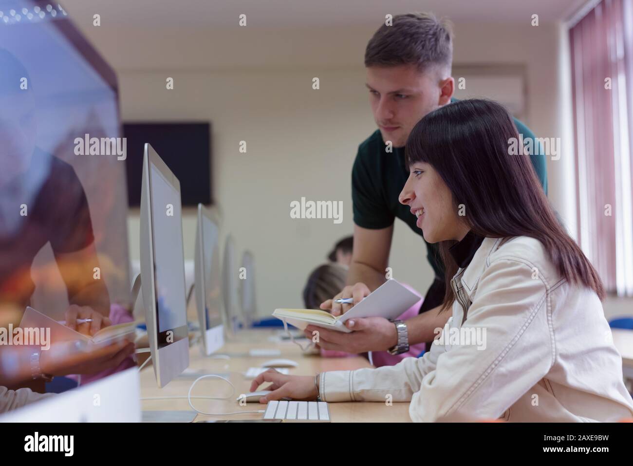 IT technologies teacher at work. IT professor explain lesson to ...