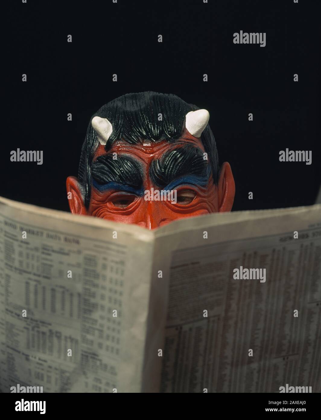 Man with devil mask reading a newspaper, Germany Stock Photo - Alamy