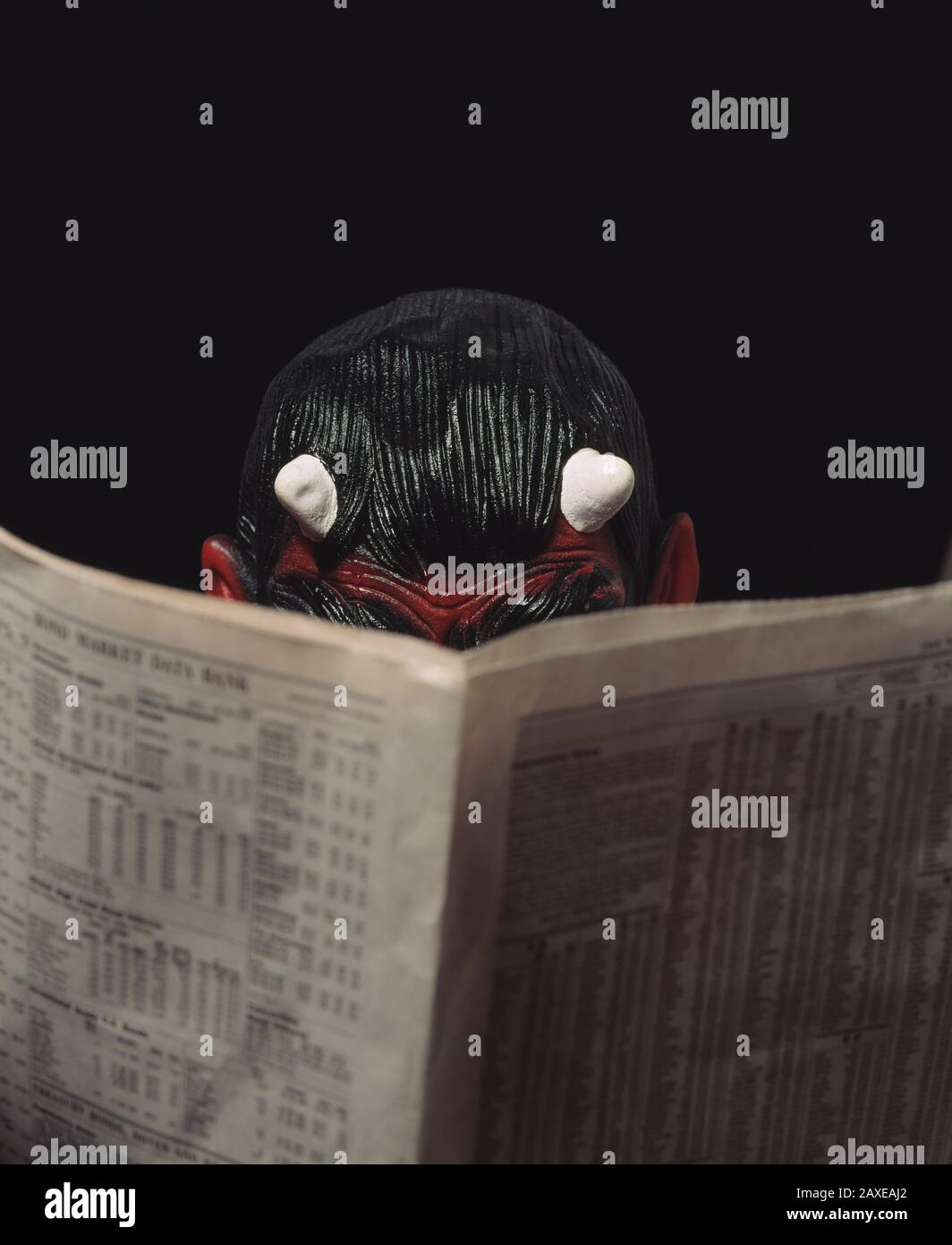 Man with devil mask reading a newspaper, Germany Stock Photo - Alamy