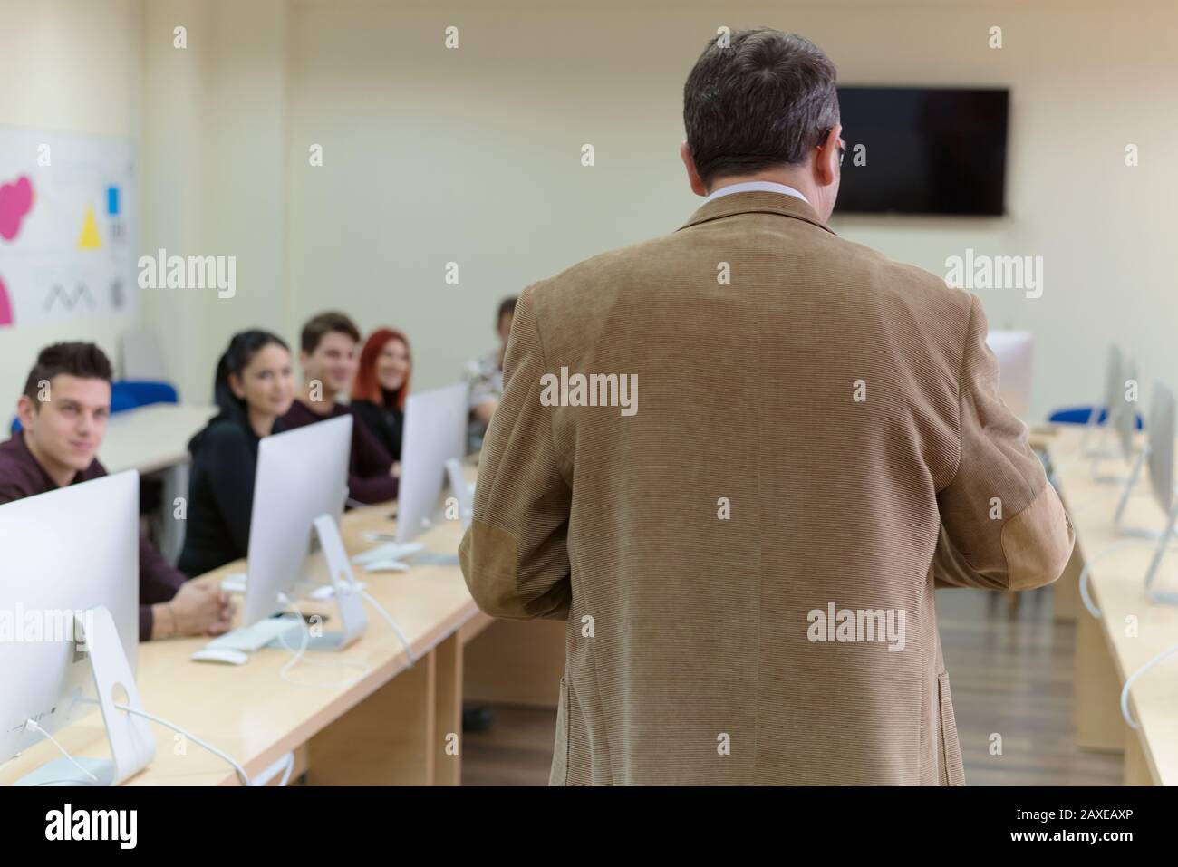 IT technologies teacher at work. IT professor explain lesson to ...