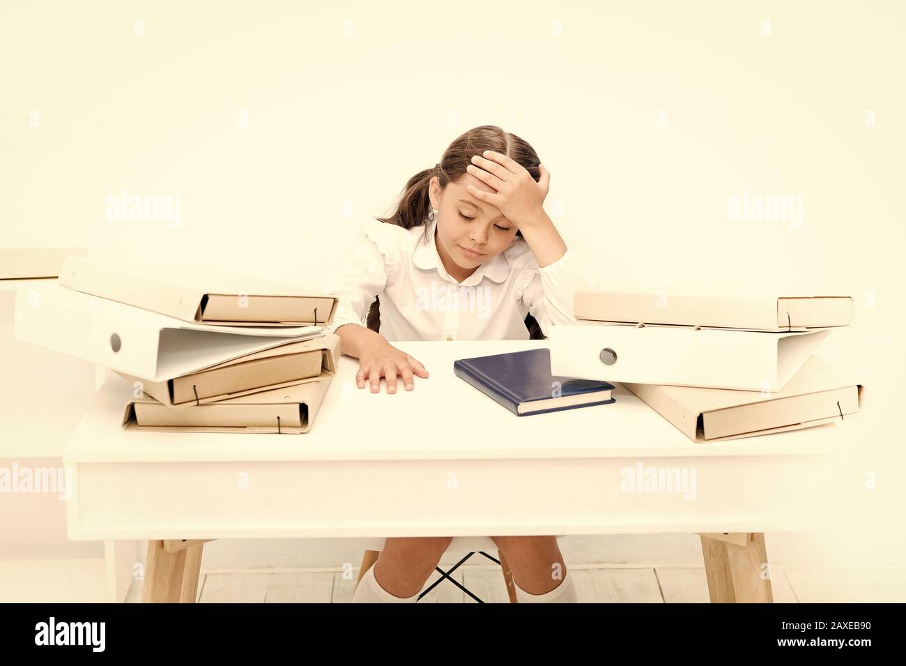 exhausted girl with workbook and folders. Education. boring lesson ...