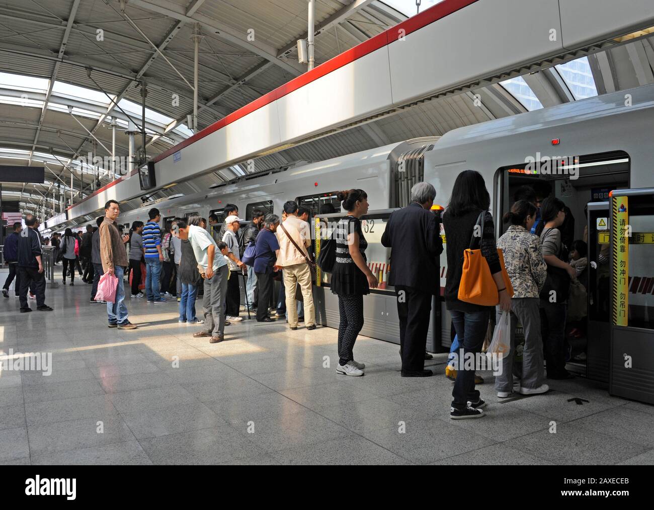 Passengers board a train at Anting station on Shanghai metro line 11 ...