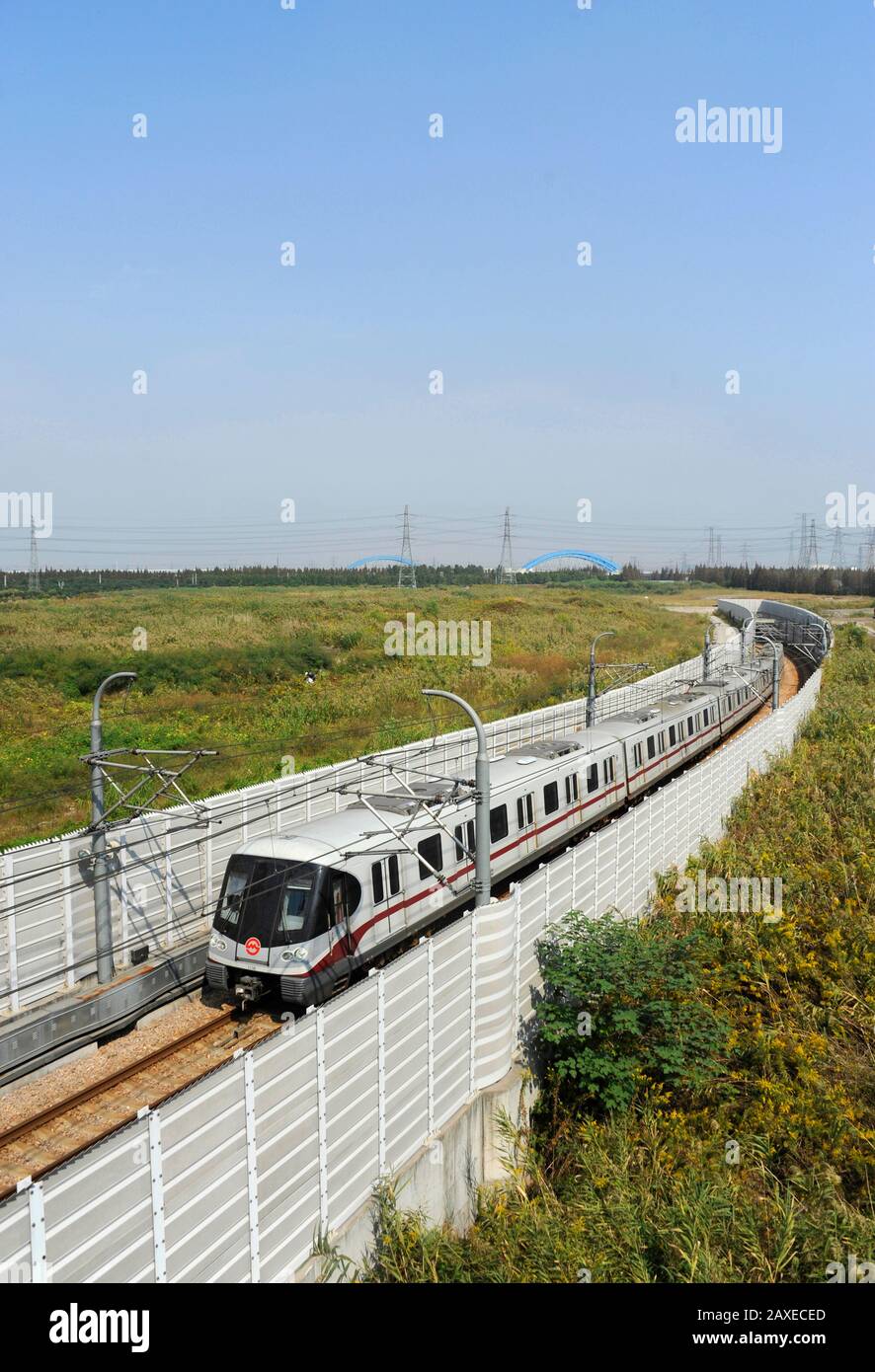 Shanghai metro line 11 train emerges from a tunnel near the motor ...