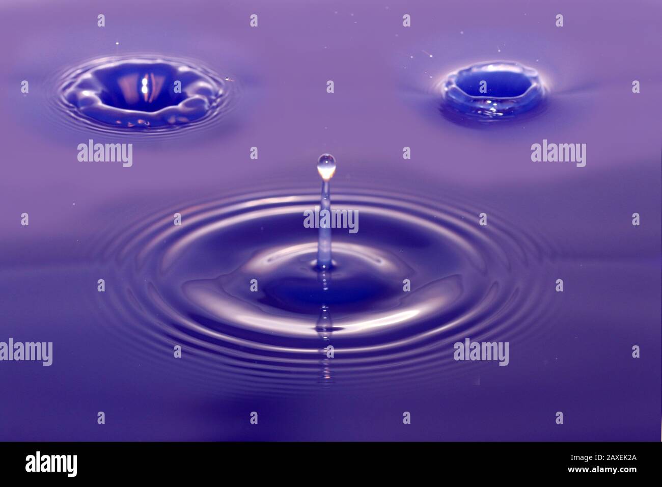 Water drops hitting surface of water Stock Photo - Alamy