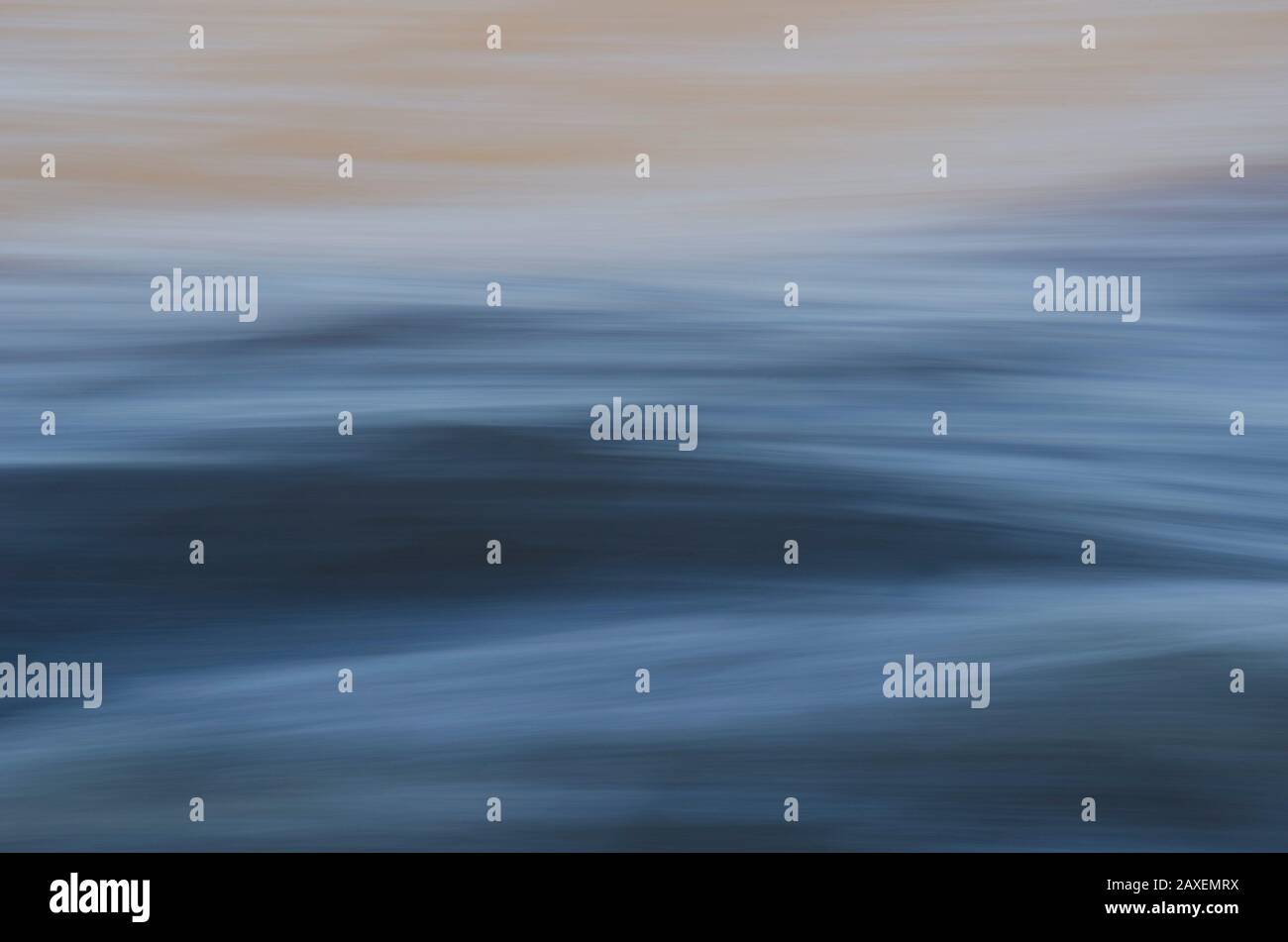 Texture of fast moving water, in gray and yellowish tones. Flow ...