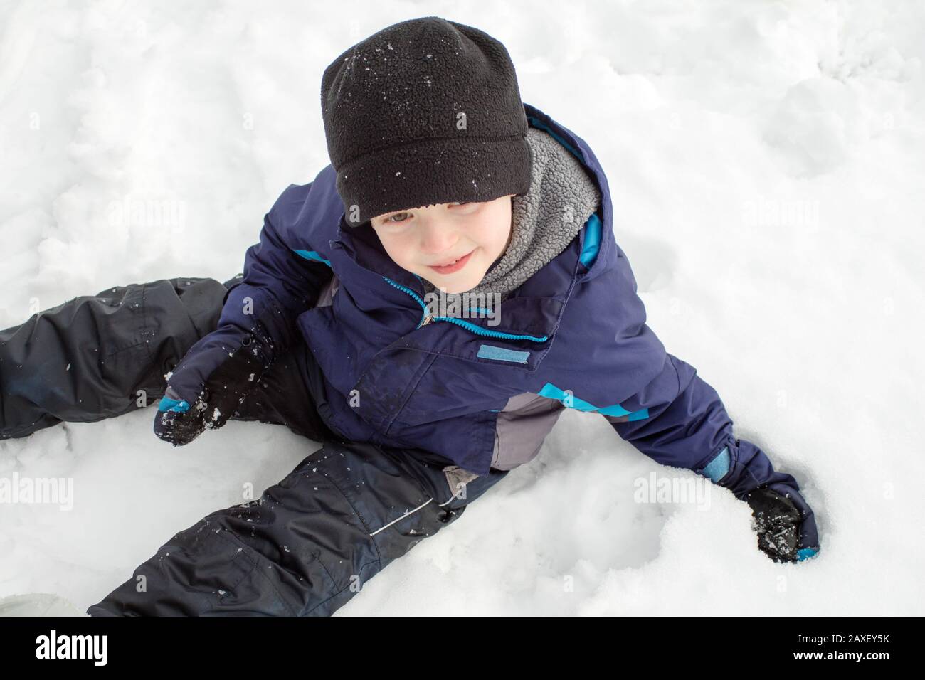 Winter Boy Playing In Snow From Above Stock Photo - Alamy