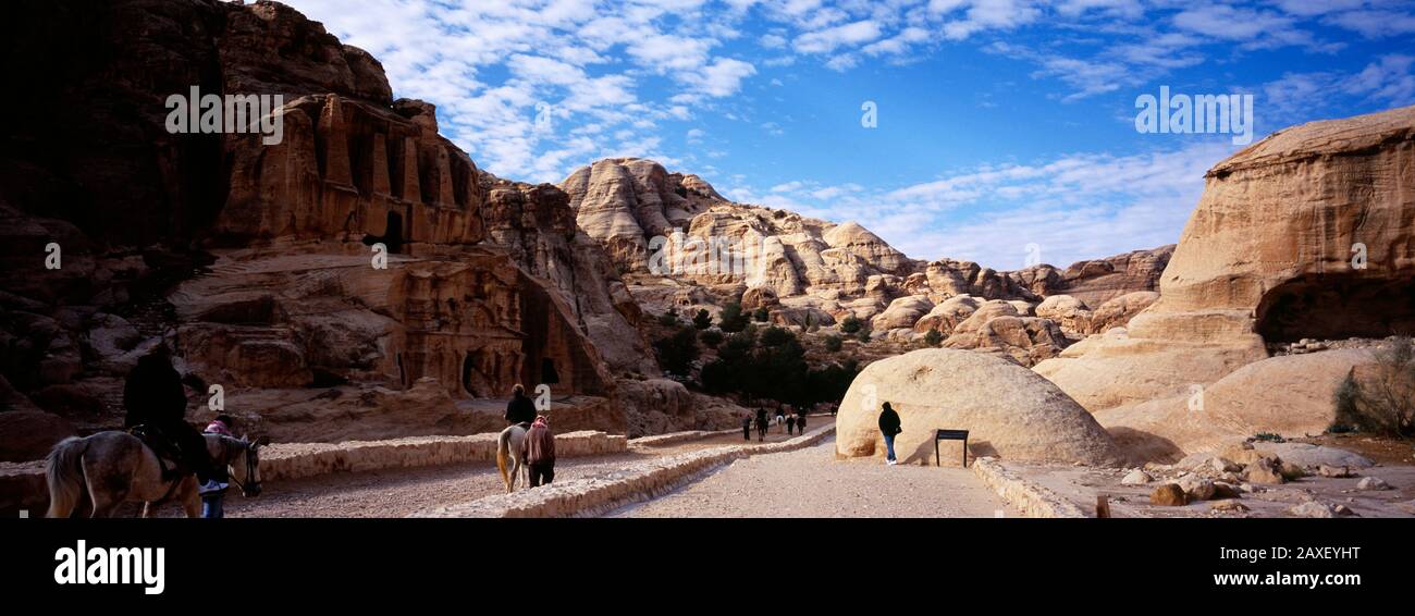 Tourists walking through ancient structures, Jordan Stock Photo - Alamy