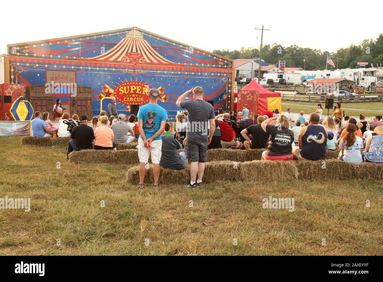 Small traveling circus performing in front of audience at country fair ...