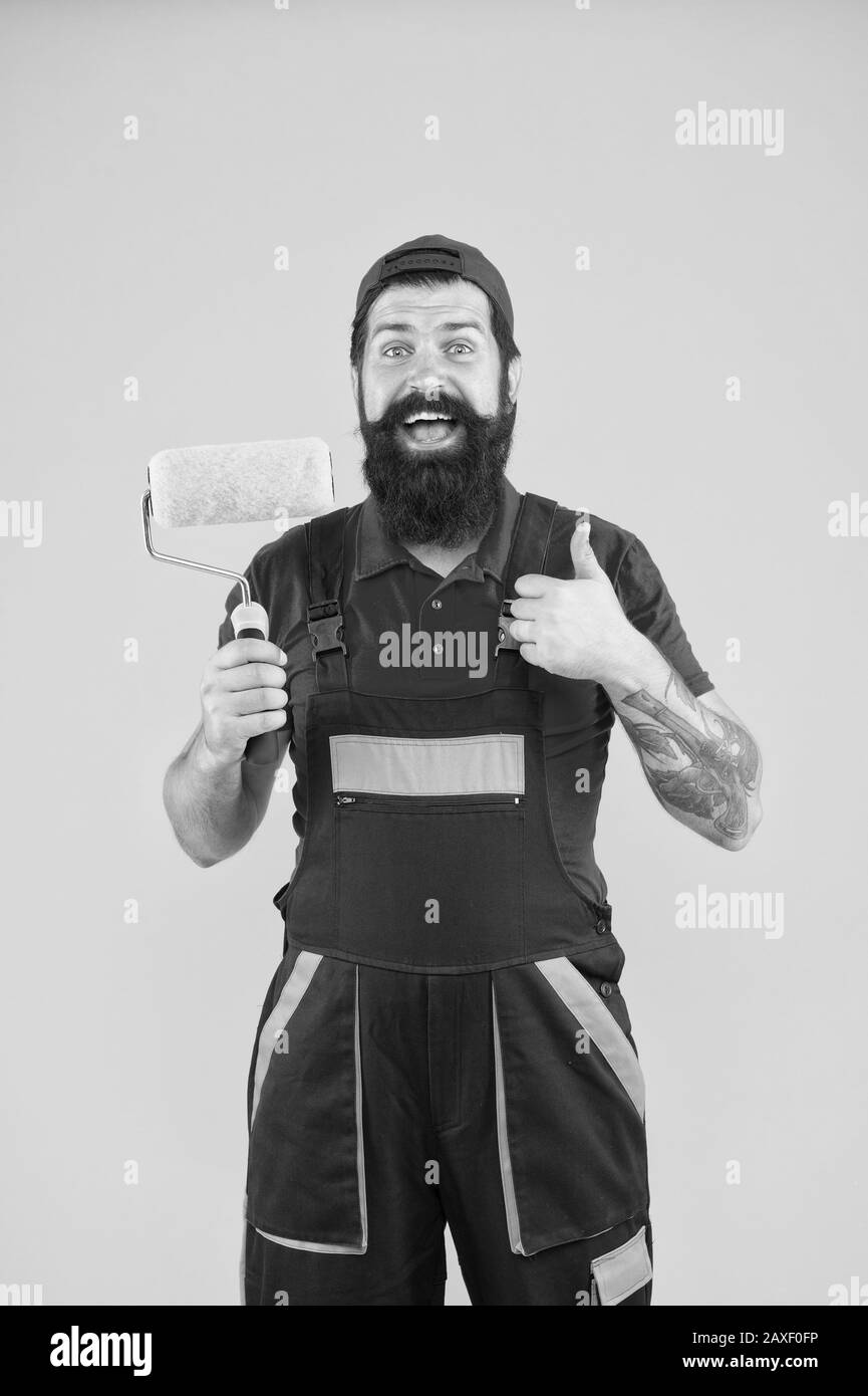 Man roller painting yellow Black and White Stock Photos & Images - Alamy