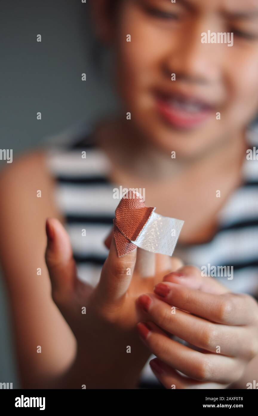 Girl first aid finger injury by herself Stock Photo - Alamy