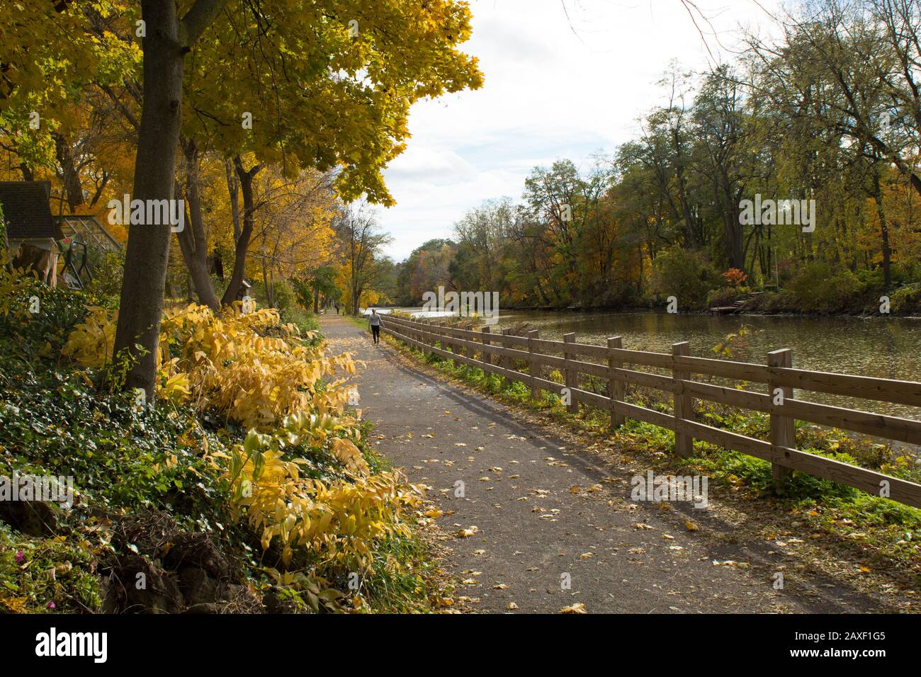Autumn Trail with wooden railing near river Stock Photo - Alamy