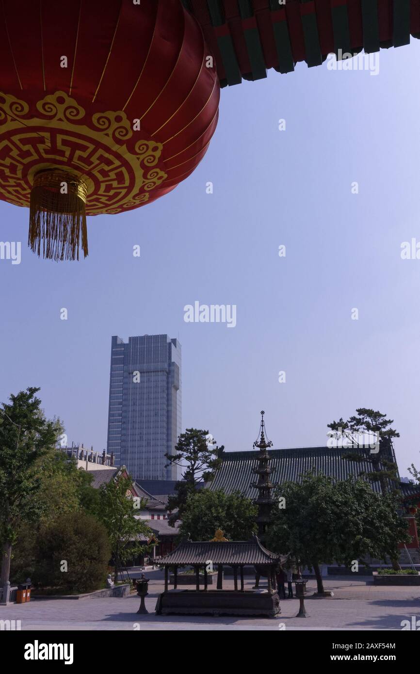 Vertical shot of a Chinese decoration in front of the buildings of a ...