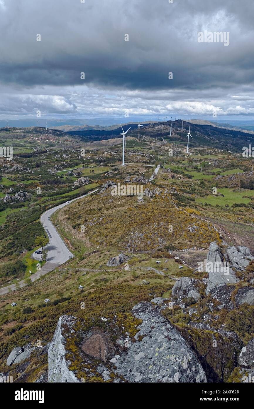 Vertical shot of white wind fans on a large grassland Stock Photo - Alamy