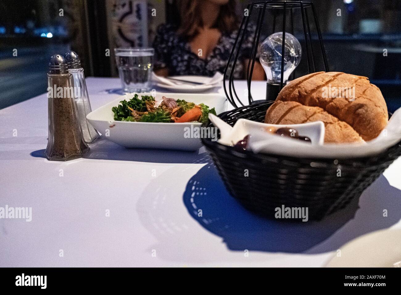 Loaf of bread and a bowl of salad served in a restaurant Stock Photo ...