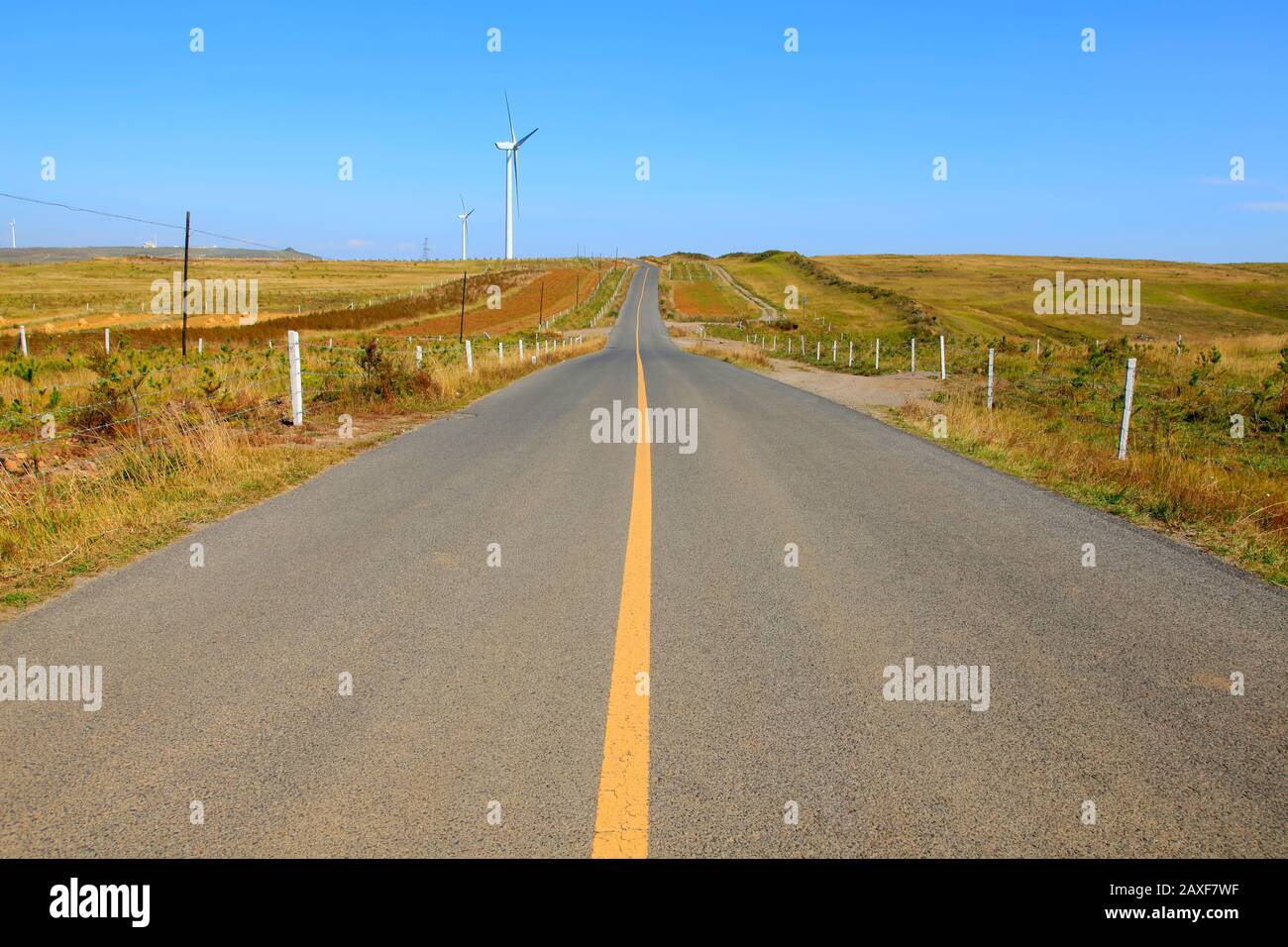 Asphalt road and wind turbines Stock Photo - Alamy