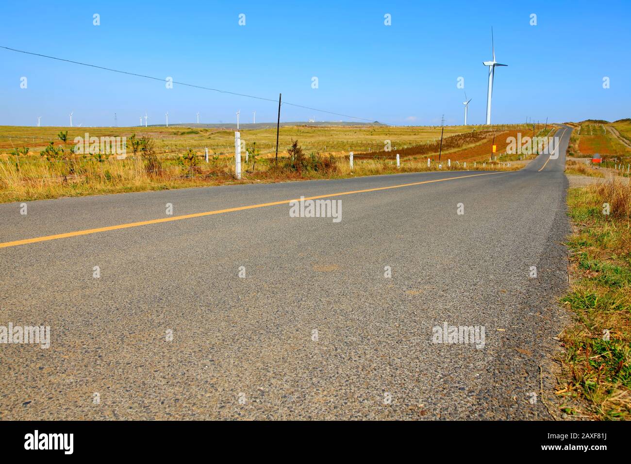 Asphalt road and wind turbines Stock Photo - Alamy