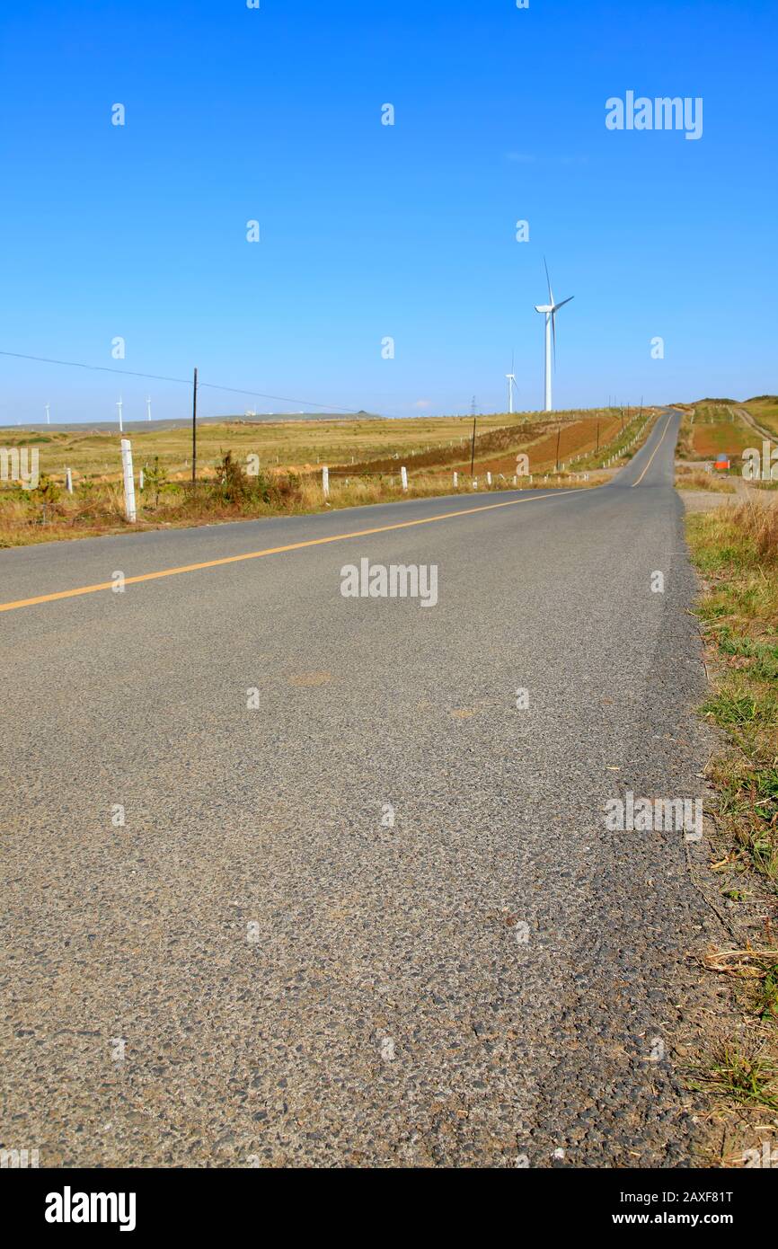 Asphalt road and wind turbines Stock Photo - Alamy