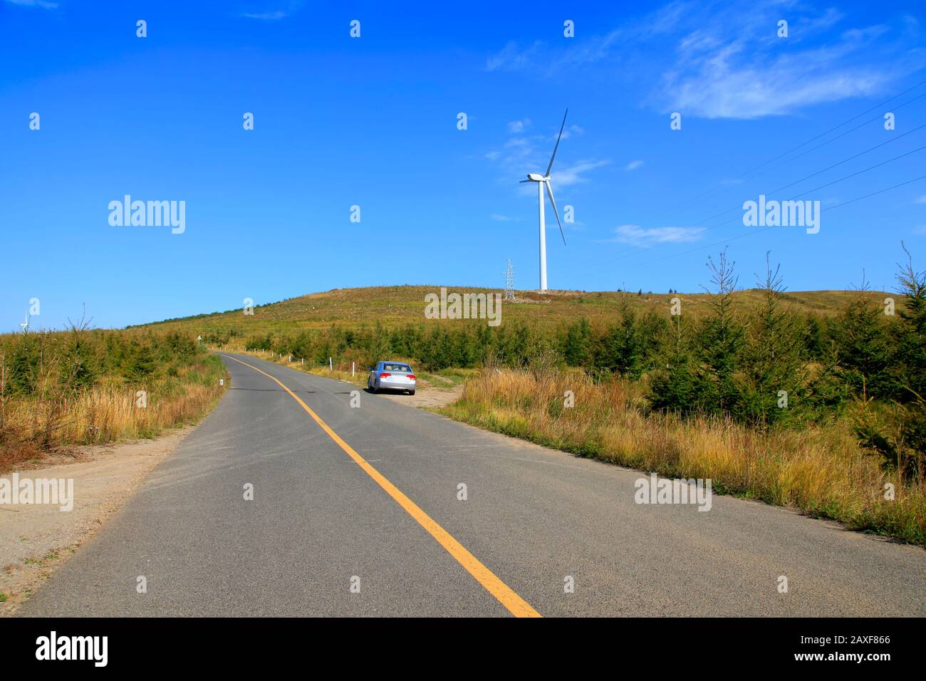 Asphalt road and wind turbines Stock Photo - Alamy