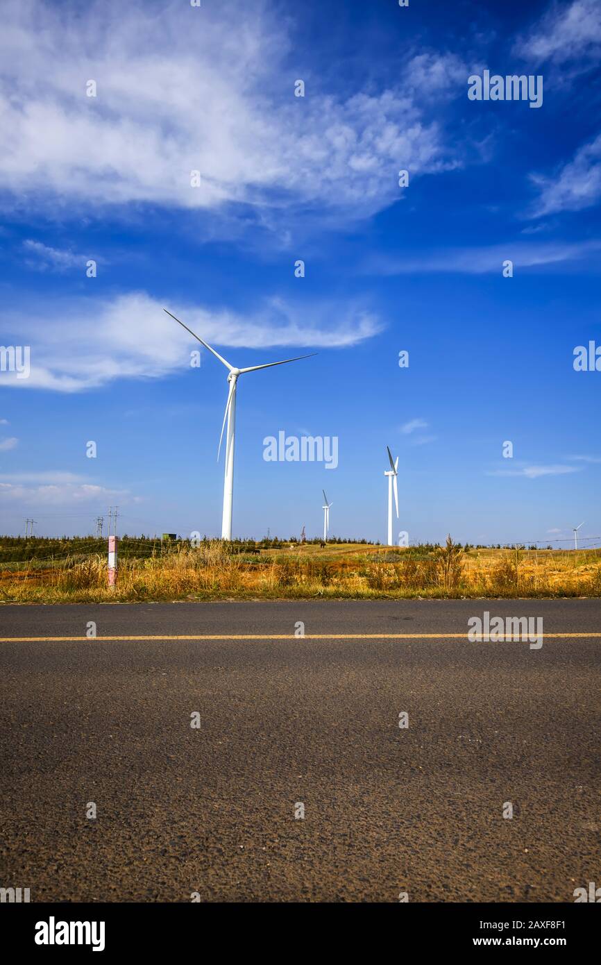 Asphalt road and wind turbines Stock Photo - Alamy