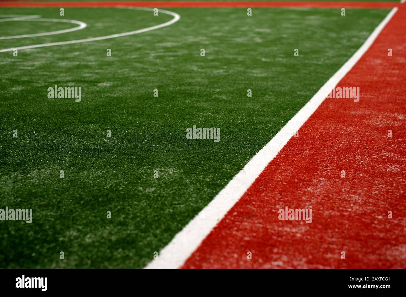 White lines on green and red artificial turf, selective view ...