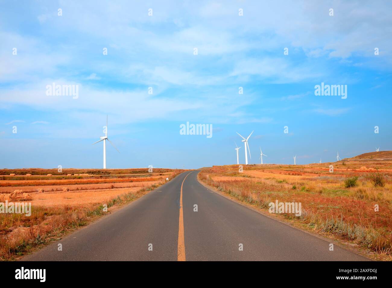 Asphalt road and wind turbines Stock Photo - Alamy