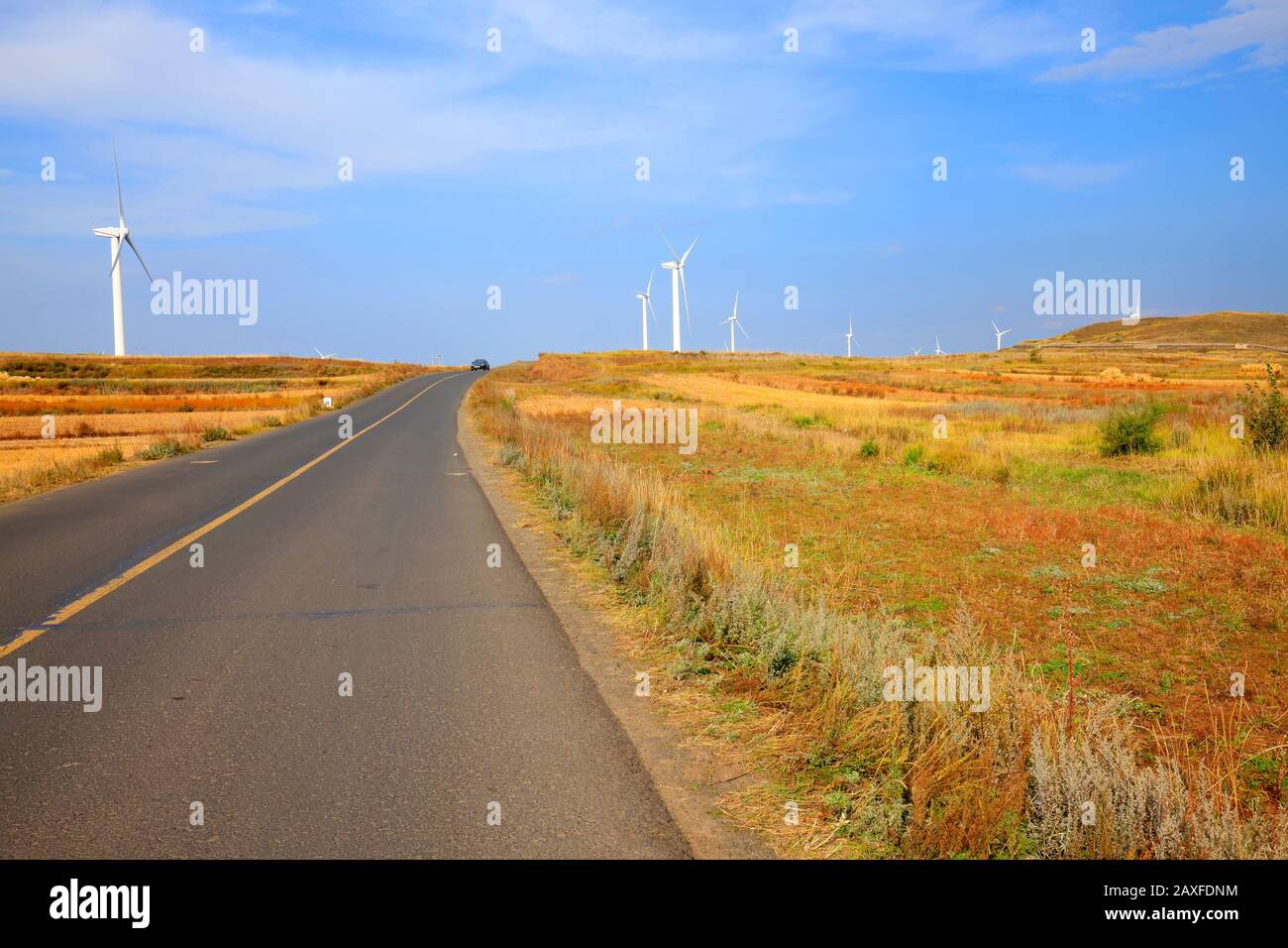 Asphalt road and wind turbines Stock Photo - Alamy