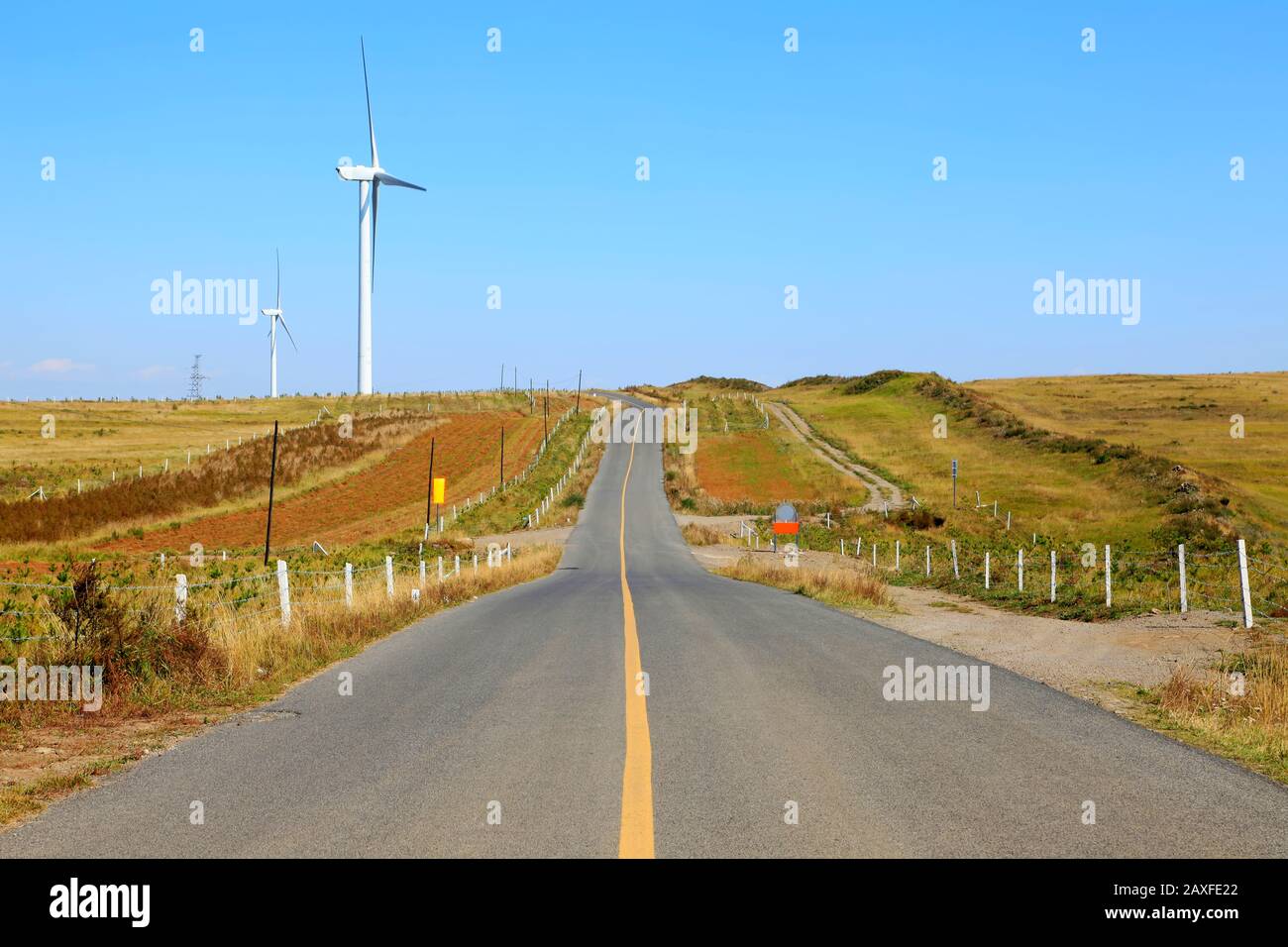 Asphalt road and wind turbines Stock Photo - Alamy