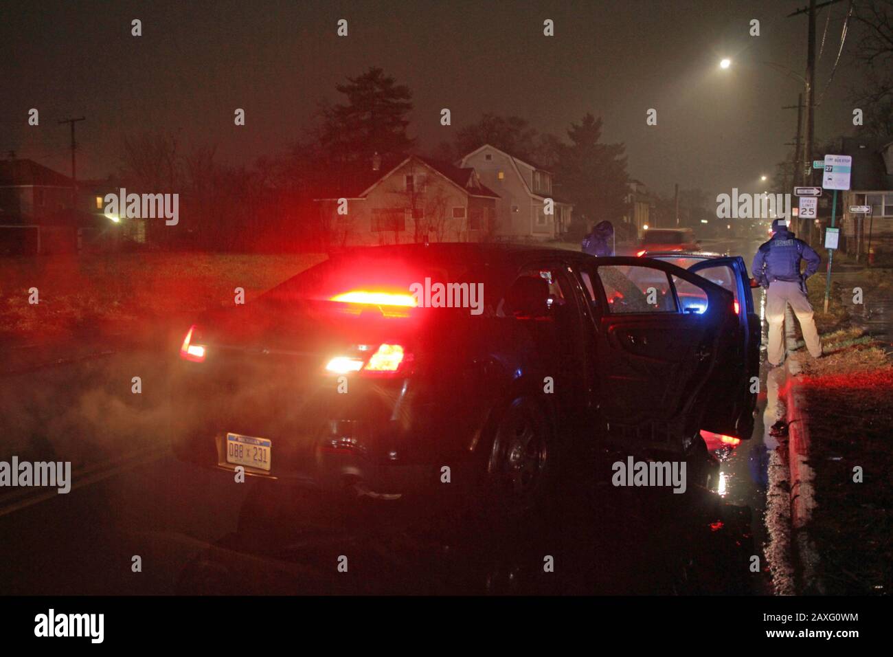 Detroit police officers speak to the driver of a car during a traffic ...