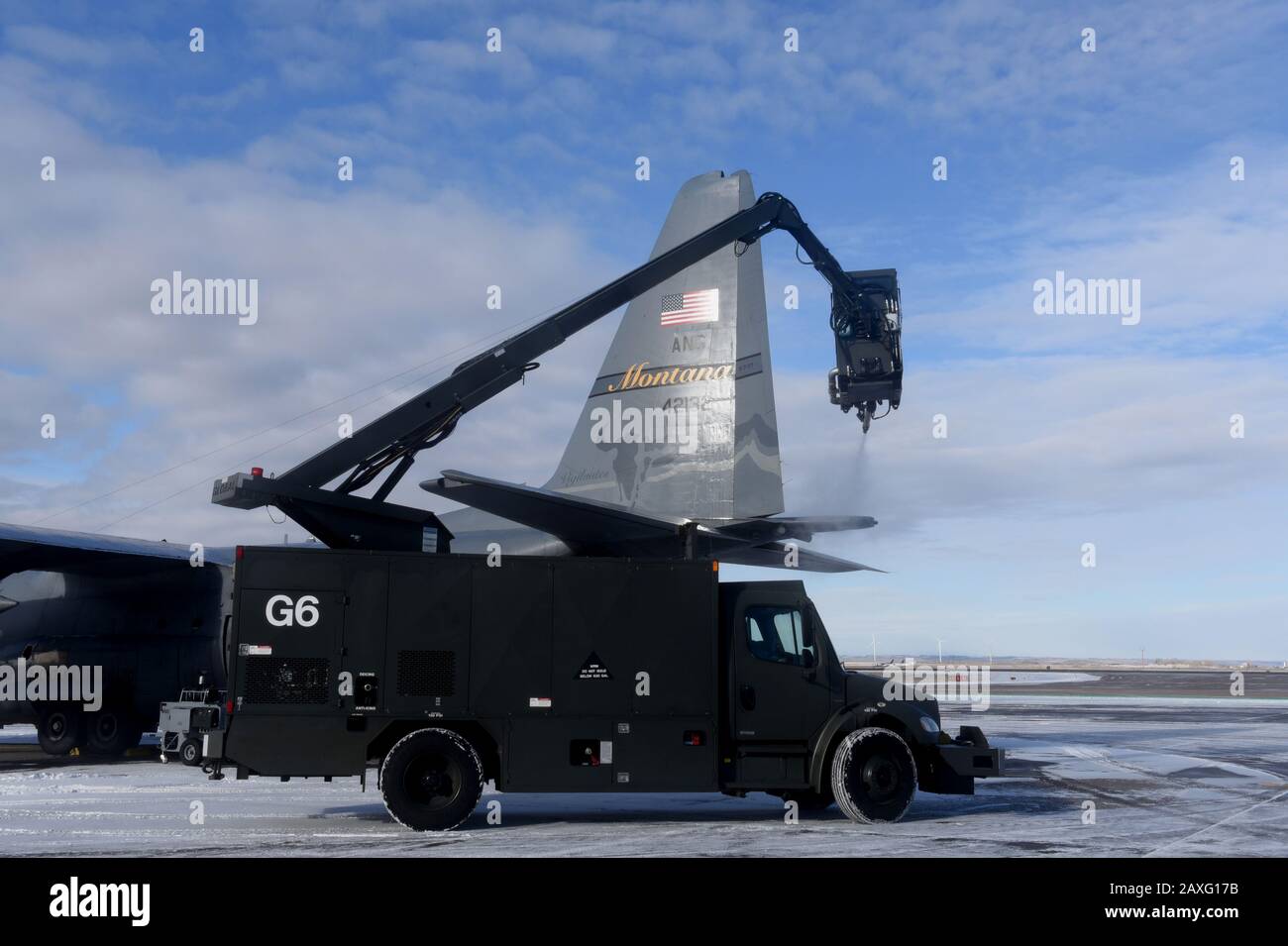 Crew chiefs with the 120th Airlift Wing Maintenance Squadron prepare a ...