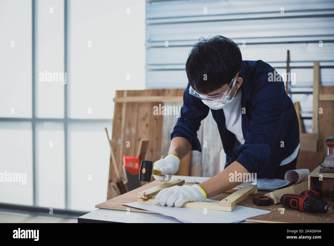 Asian man Carpenter working with technical drawing or blueprint ...