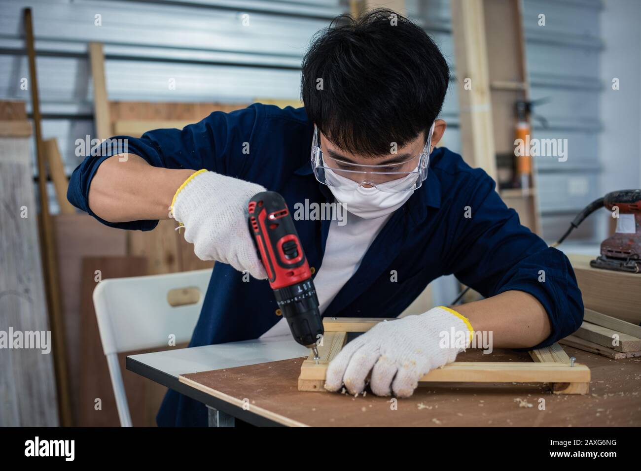 Asian man Carpenter working with technical drawing or blueprint ...