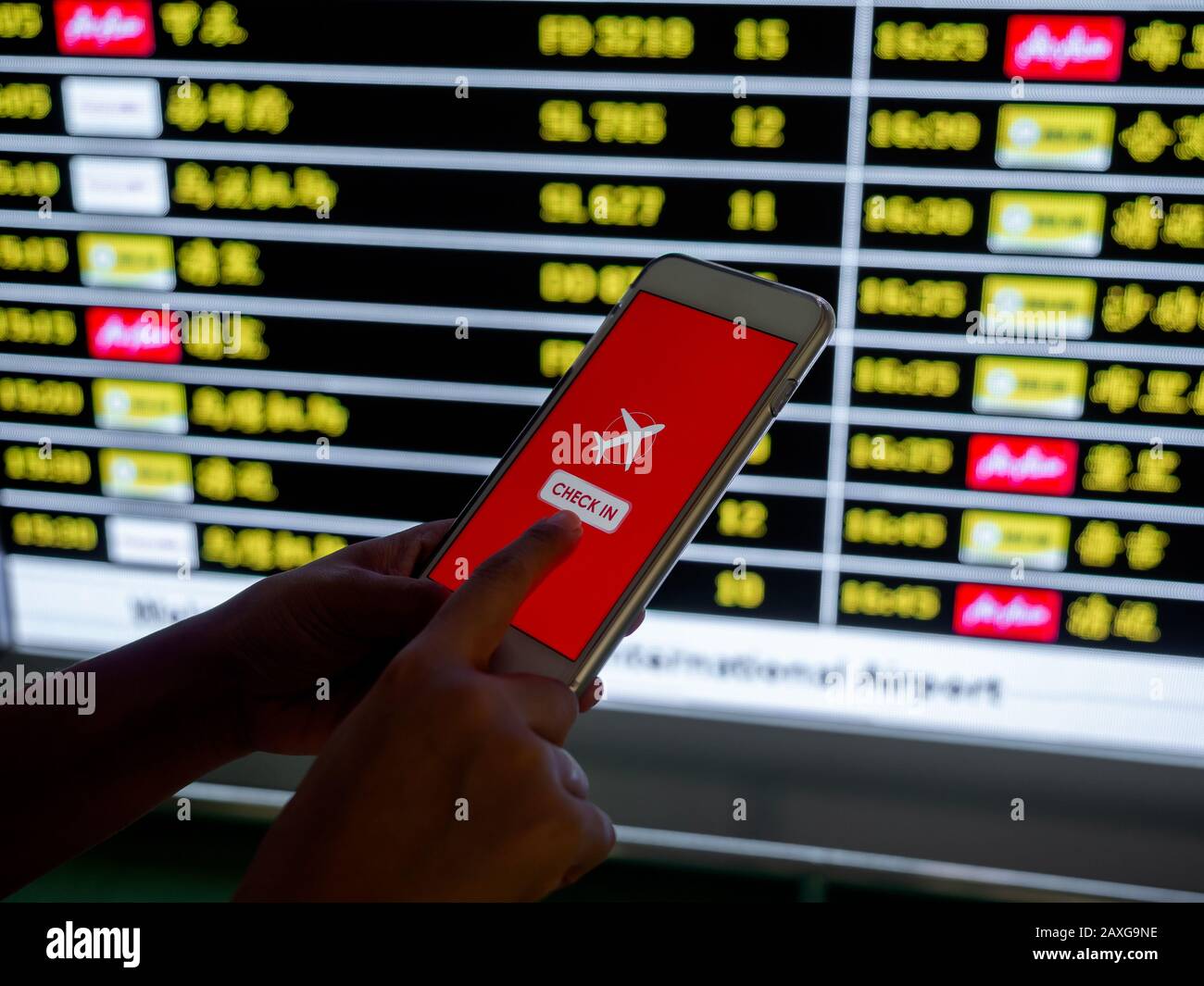 Flight check-in by mobile phone. Hand touching on smartphone screen to ...