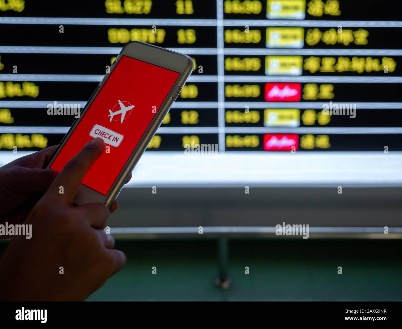 Flight check-in by mobile phone. Hand touching on smartphone screen to ...
