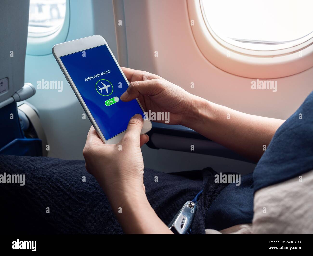 Flight mode concept. Hand holding white smartphone and turned on ...