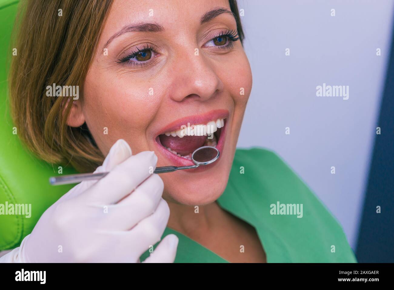 Closeup of a female patient with an open mouth during oral checkup at ...