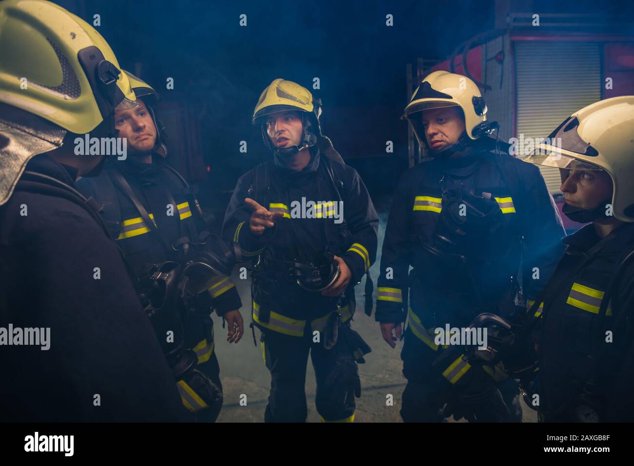 Group of firemen in the fire department organizing action plan for safe ...