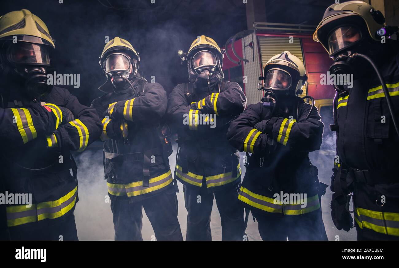 Team of fireman standing the middle of the fire extinguisher's smoke ...