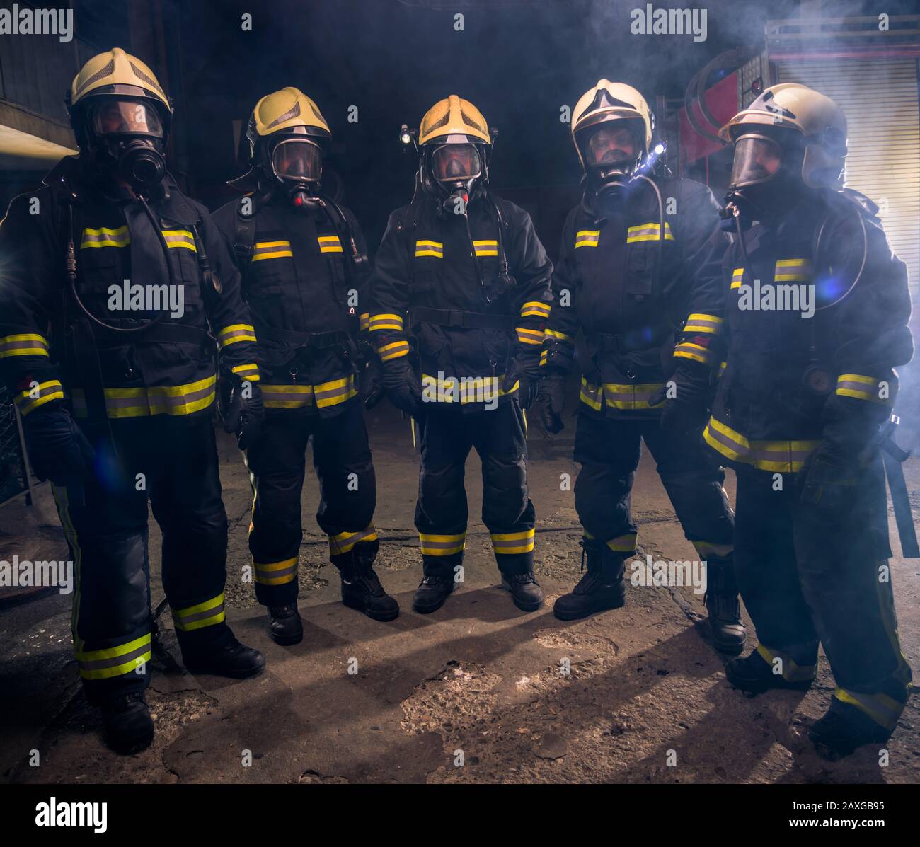 Portrait of group of firefighters in the middle of the smoke of the ...