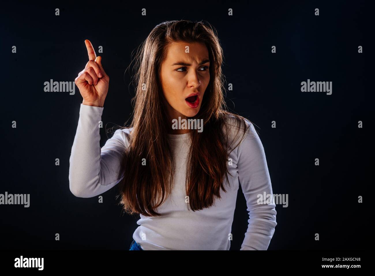 Beautiful angry brown-haired angry girl accusing everyone isolated over ...
