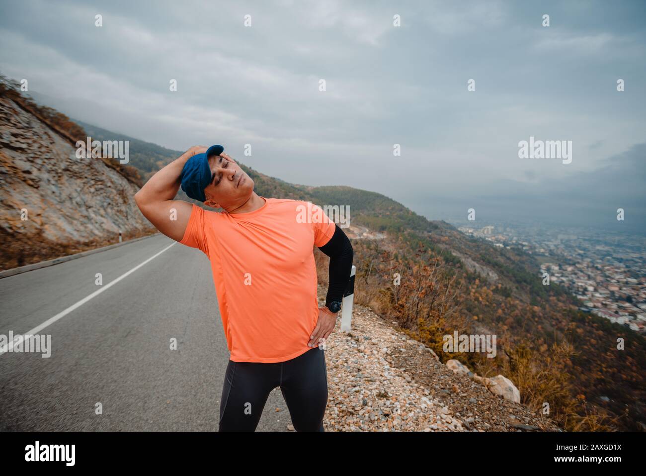 Fit athletic mature runner during a running exercise preparation Stock ...