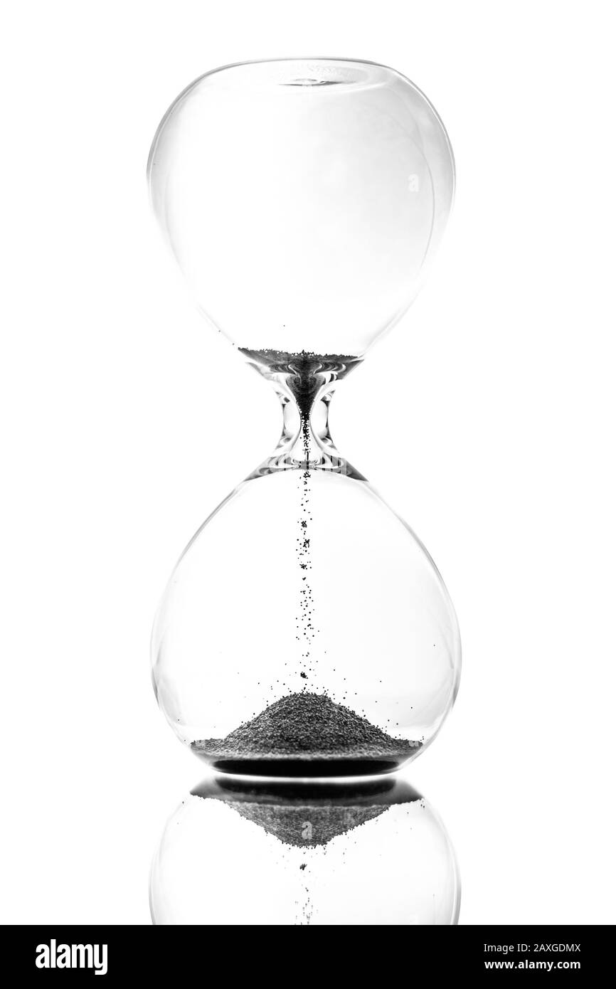 An hourglass flowing in a white background Stock Photo - Alamy