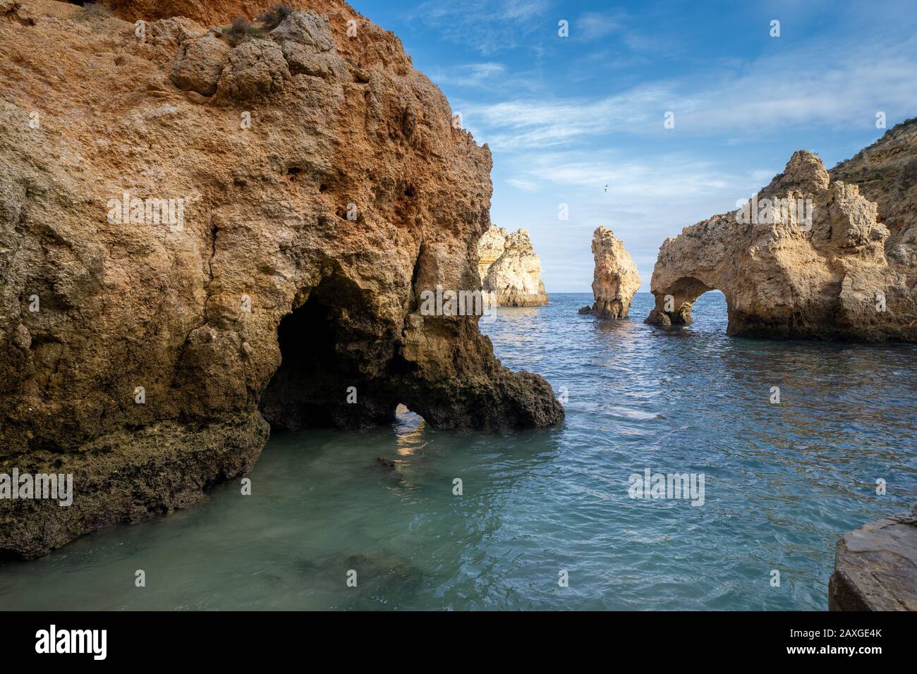 Scenic natural cliff formations and arches of Algarve coastline with ...