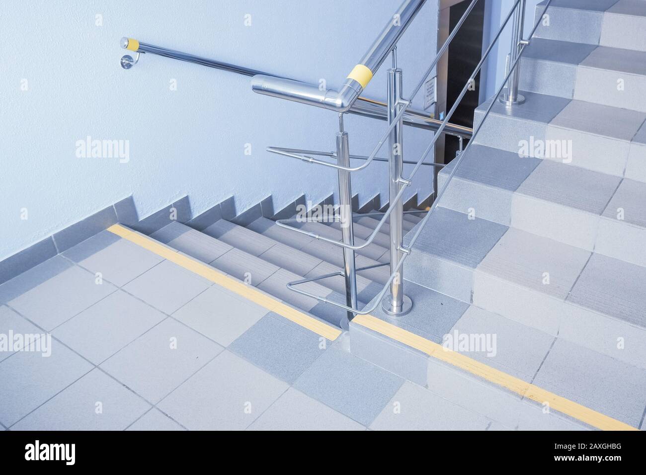 Men standing on top of staircase and stop waiting to walk down the ...