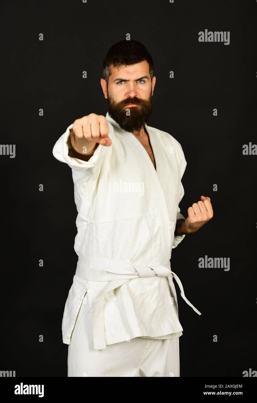 Karate man with confident face in uniform. Taekwondo master practices ...